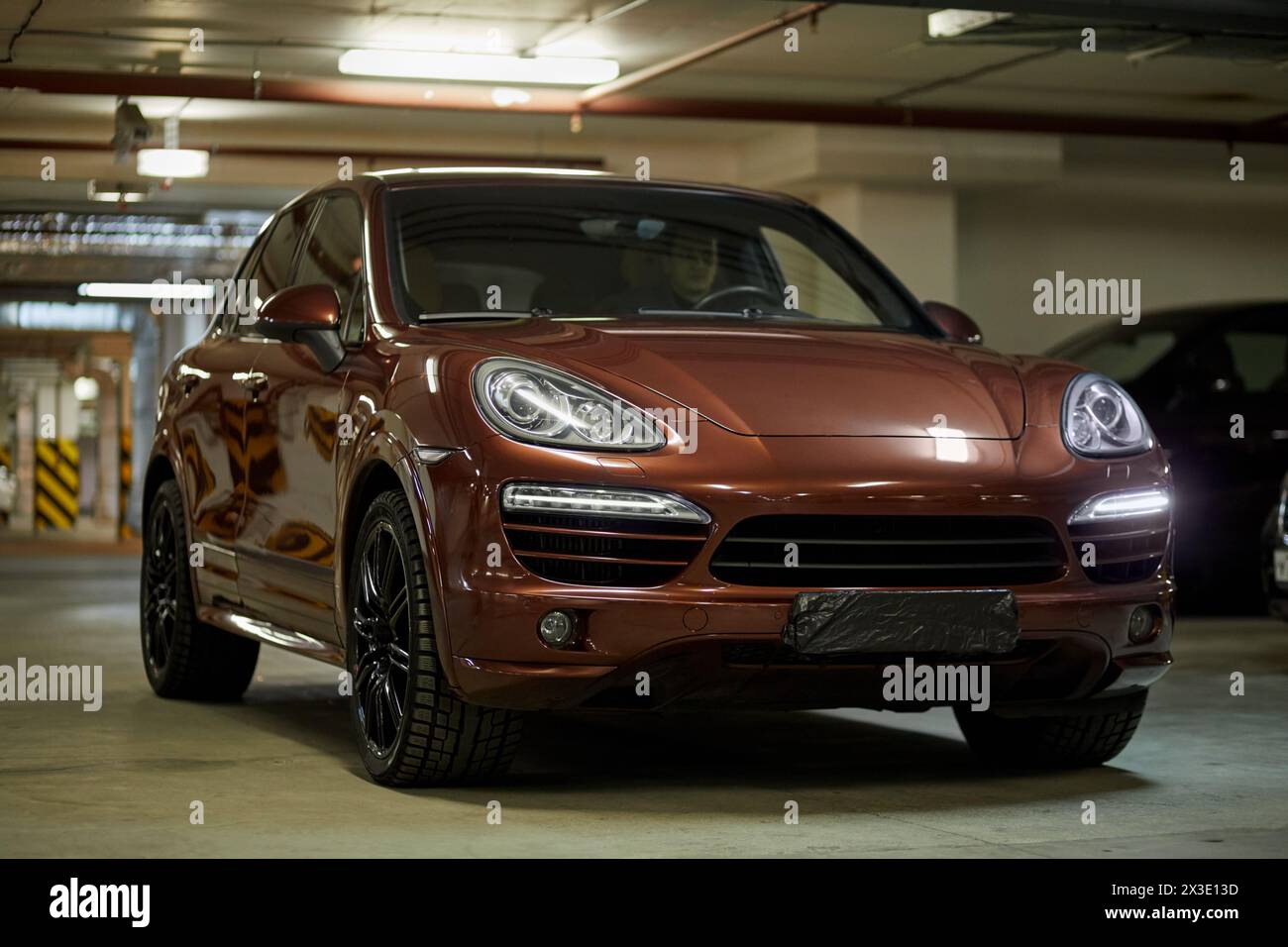 New brown sports car with driver inside at underground parking Stock ...