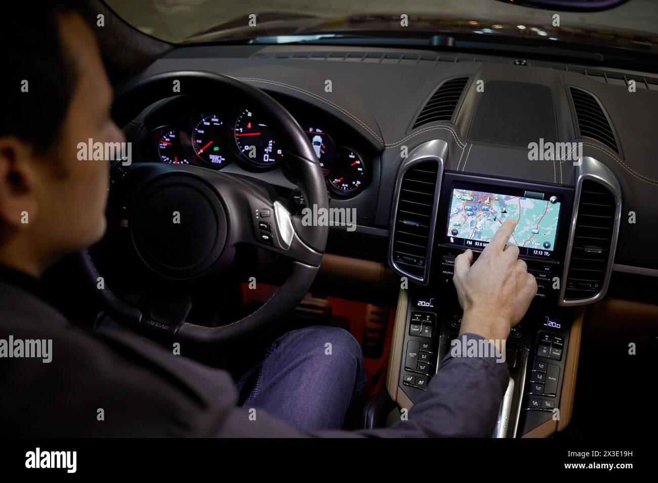Man driver operates navigator in cabin of modern car Stock Photo - Alamy