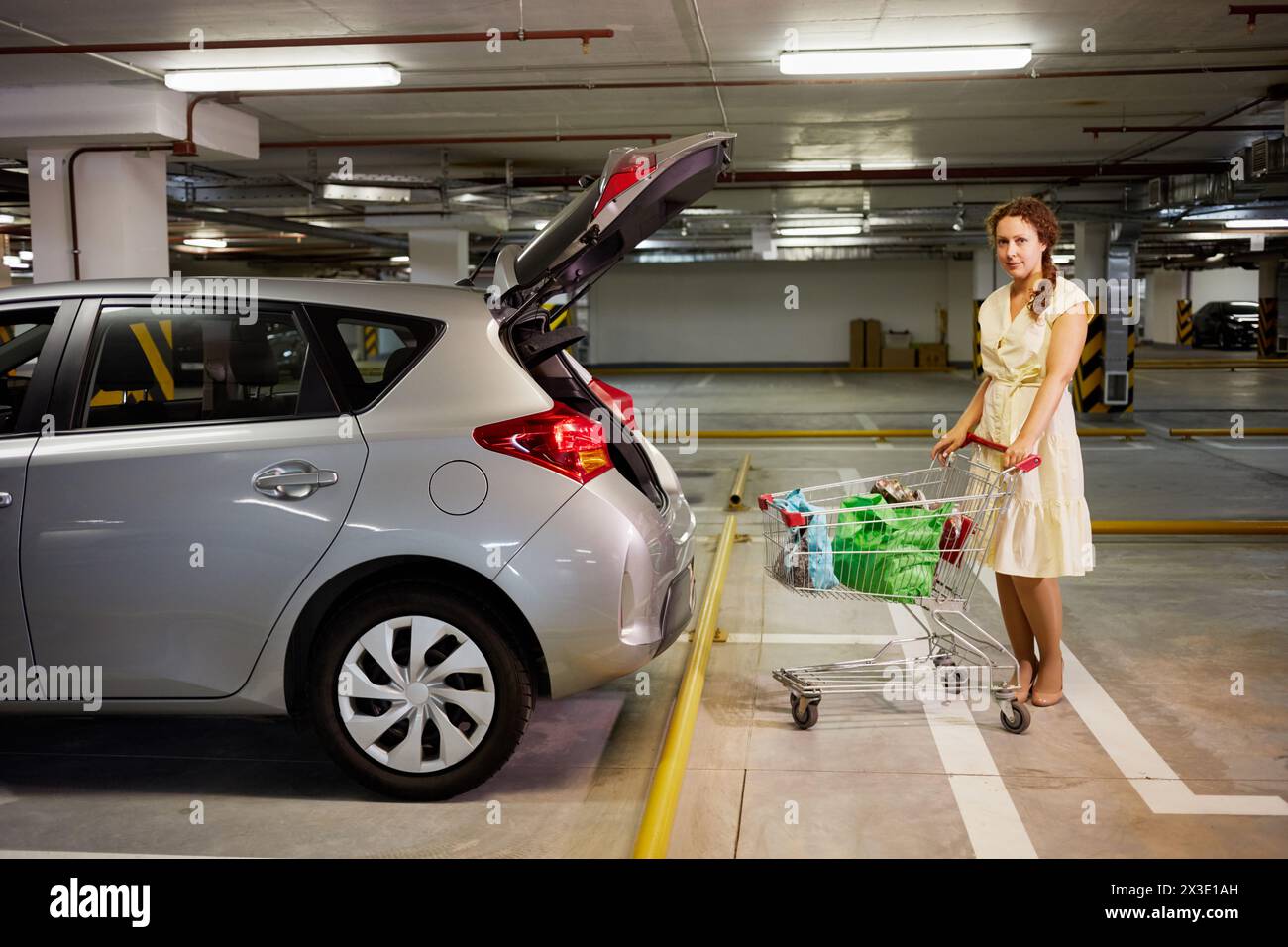 Woman loading car with grocery shopping hi-res stock photography and ...