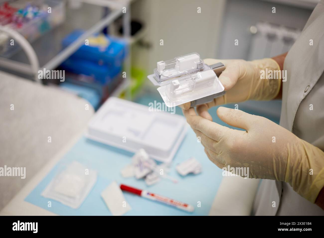 Doctor hands in gloves, holding piercing devices Stock Photo - Alamy