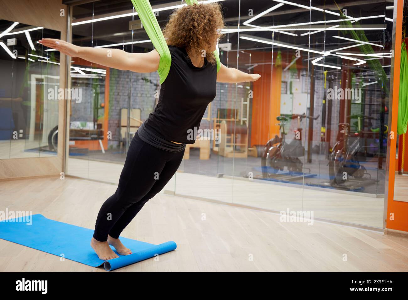 Woman doing exercise in gym with hammock for air flying yoga Stock ...