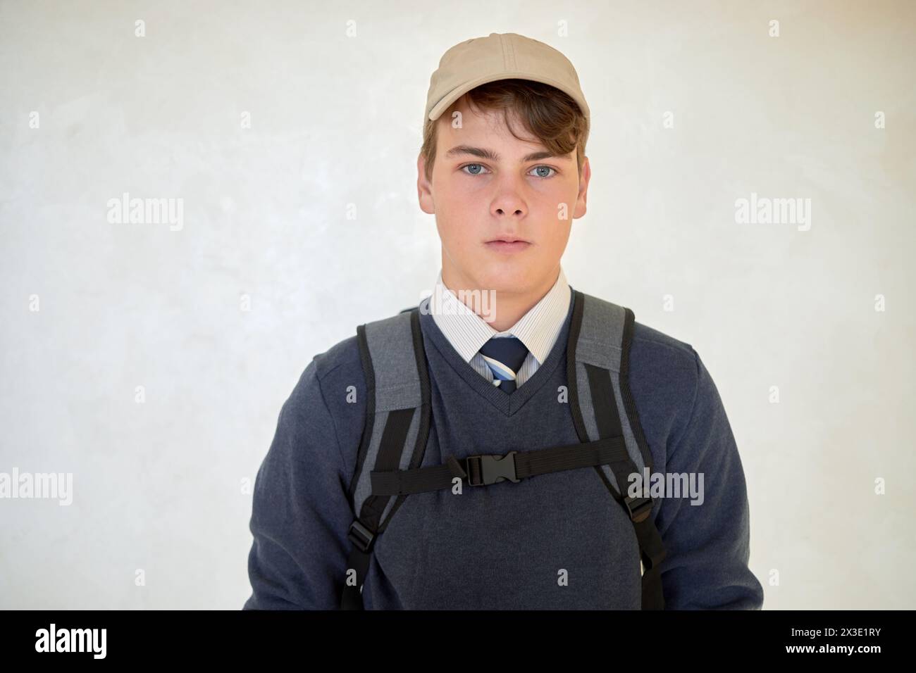 Portrait of schoolboy in cap with rucksack Stock Photo - Alamy