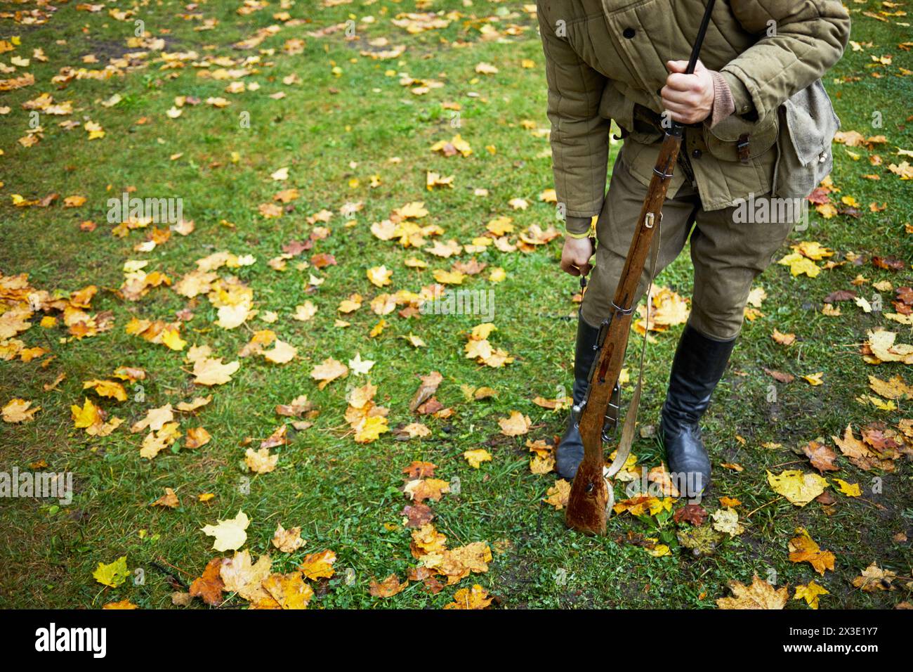Man with rifle dressed in soviet soldier uniform of World War II hides ...