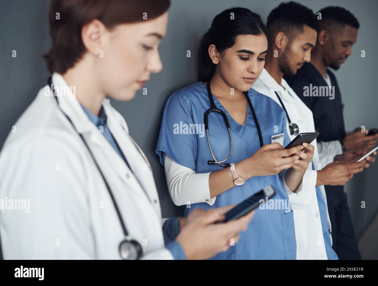 Nurses, doctors and row by wall with technology for waiting with social ...
