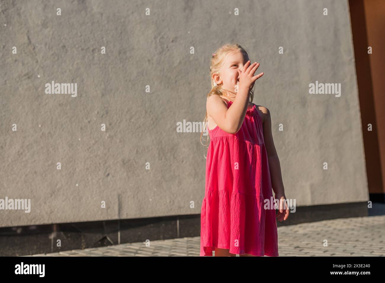 Child with hearing problem and cochlear implant plays in street, deaf ...