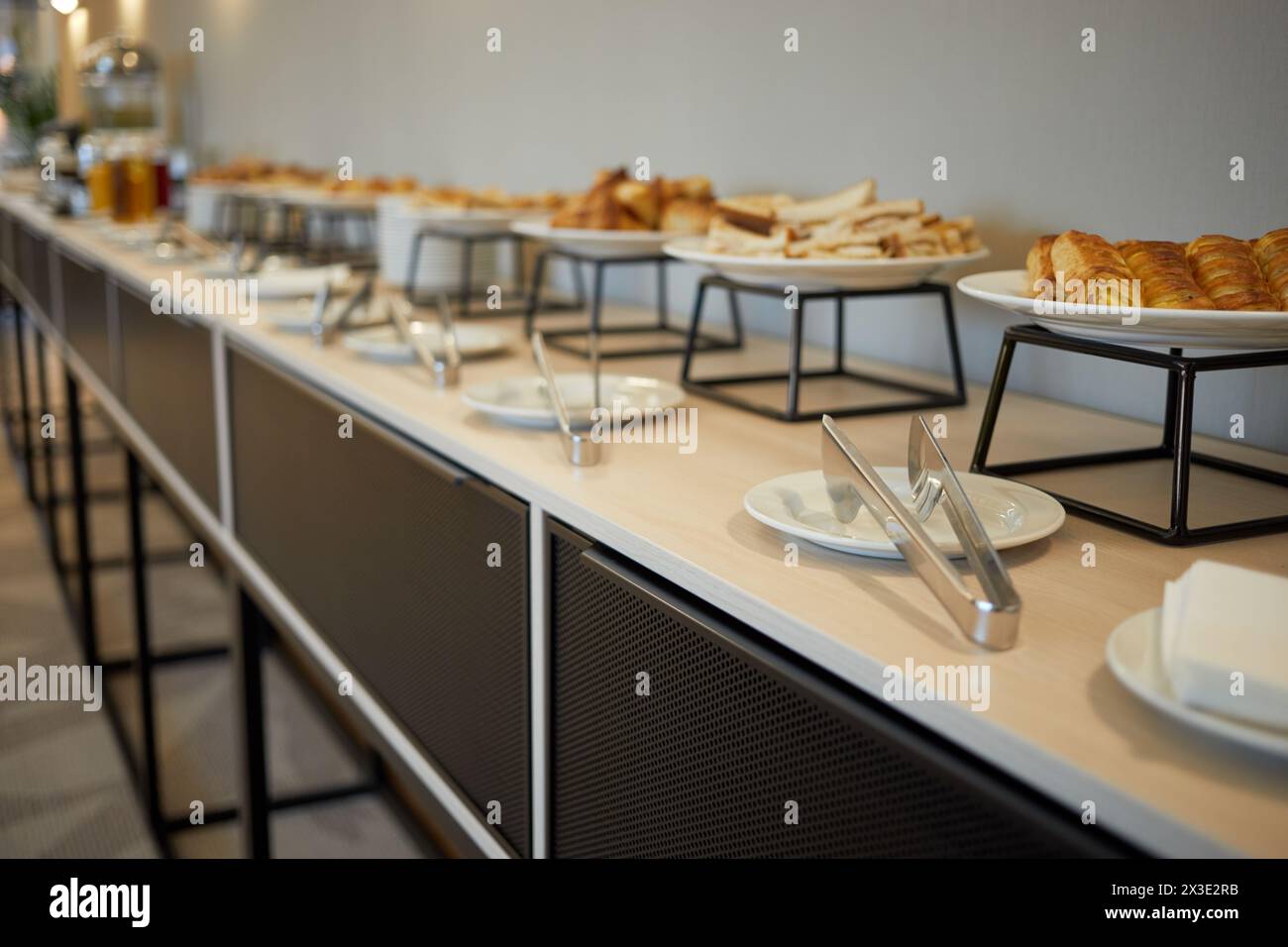 Counter with trays of cakes, plates and food tongs, shallow dof Stock ...