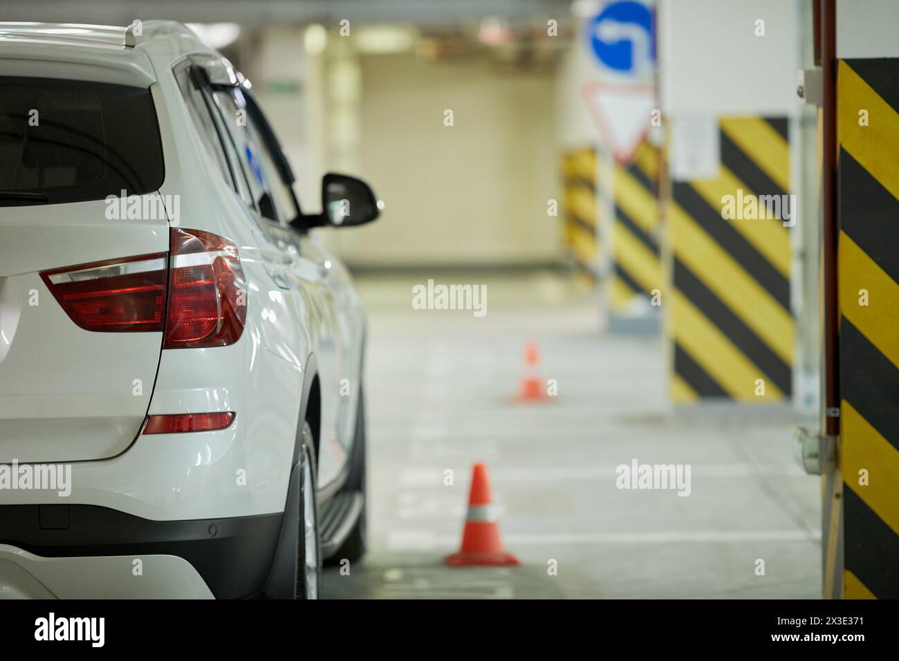Right side of modern white car at underground parking, rear view Stock ...
