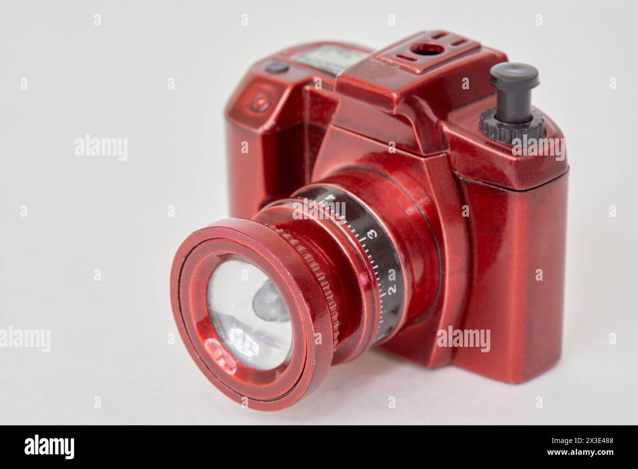 Red flashlight made in form of camera on white background Stock Photo ...