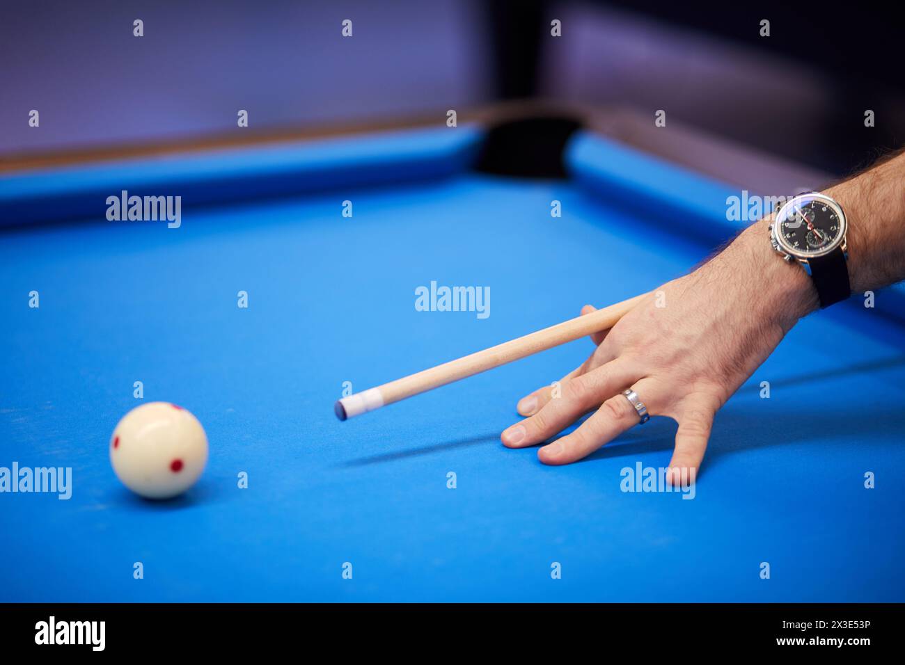Male hand and cue stick aiming ball on pool table Stock Photo - Alamy