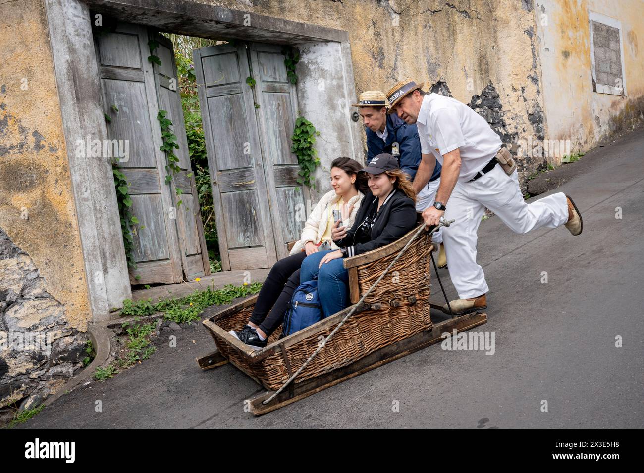 Tourist passengers ride Funchal's famous 'Carreiros de Monte' toboggan ...