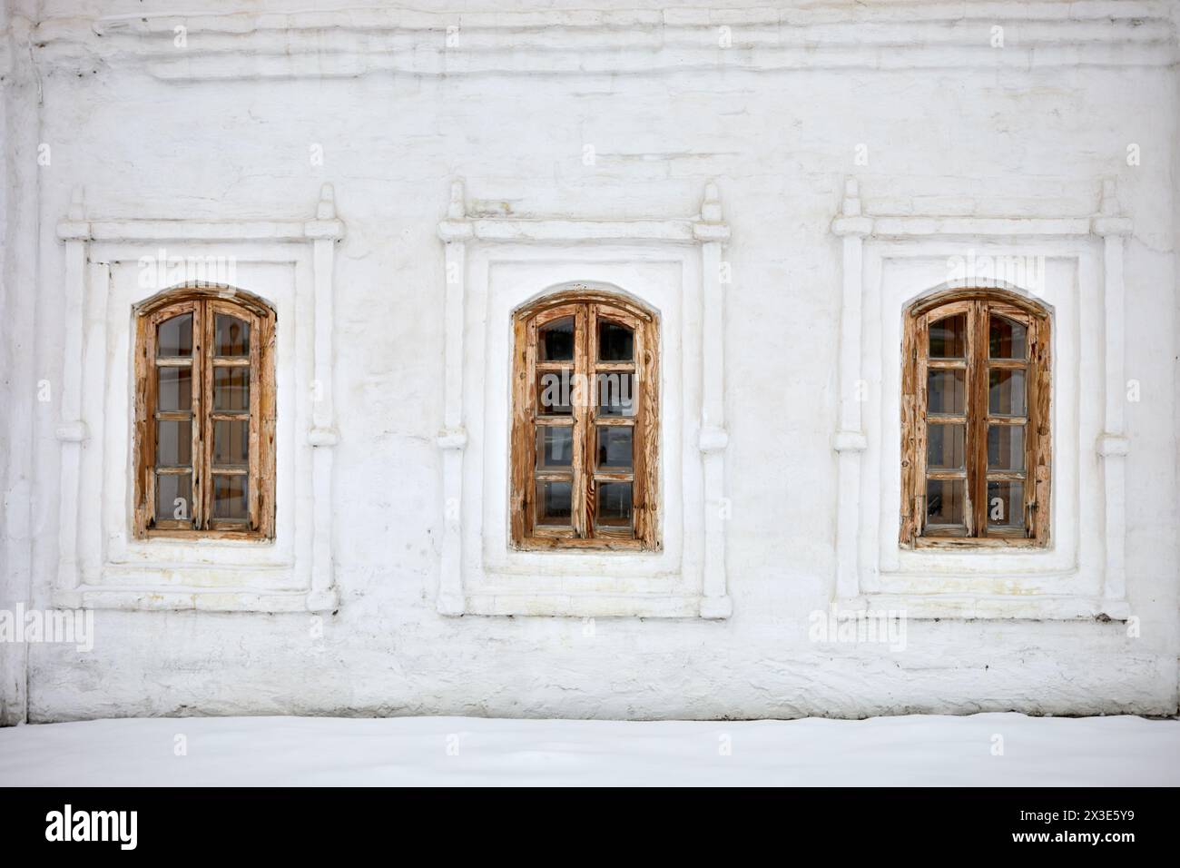 Wall with three windows of old whitewashed house on winter day Stock ...