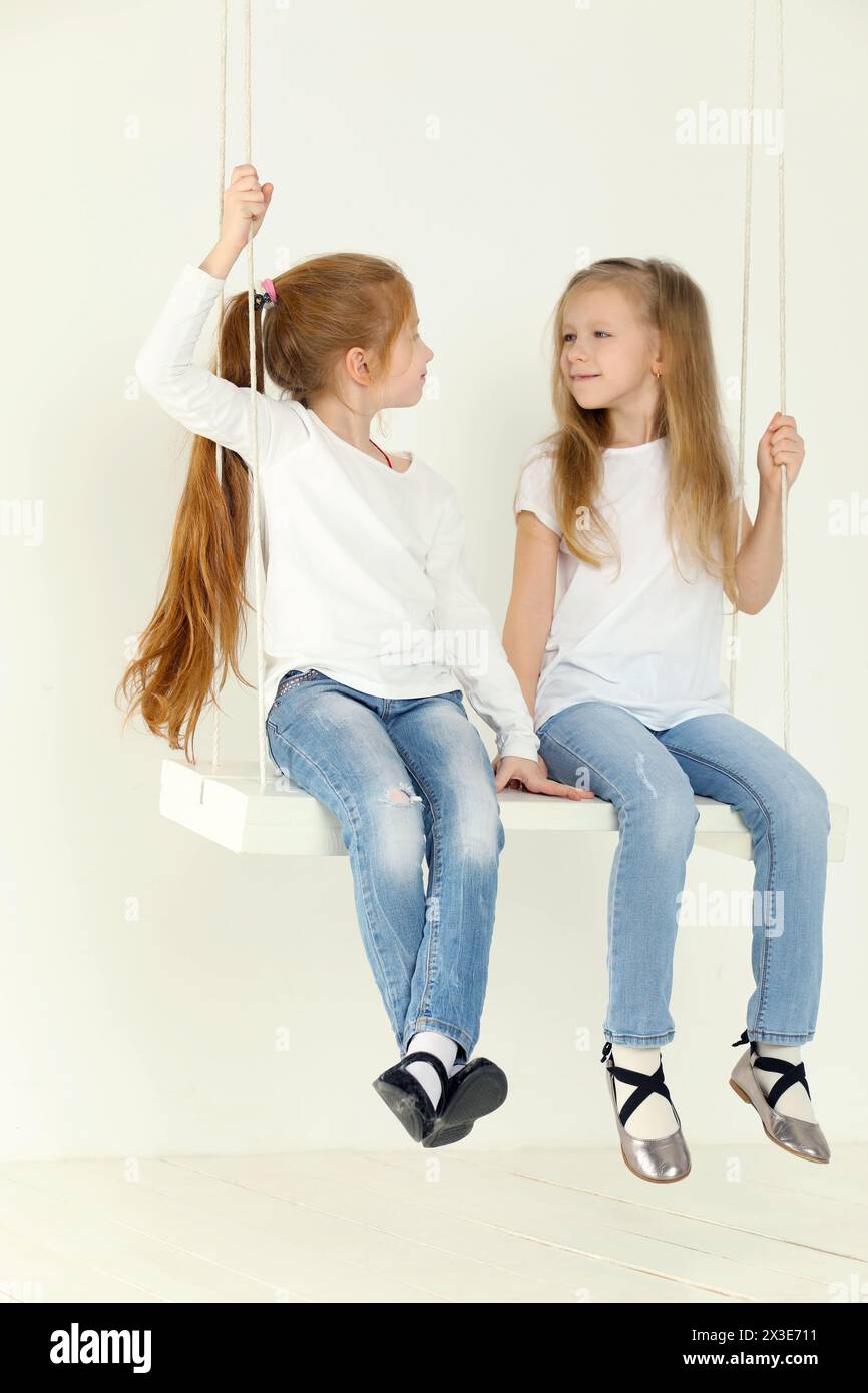 Girls playing swinging swing rope hi-res stock photography and images - Alamy