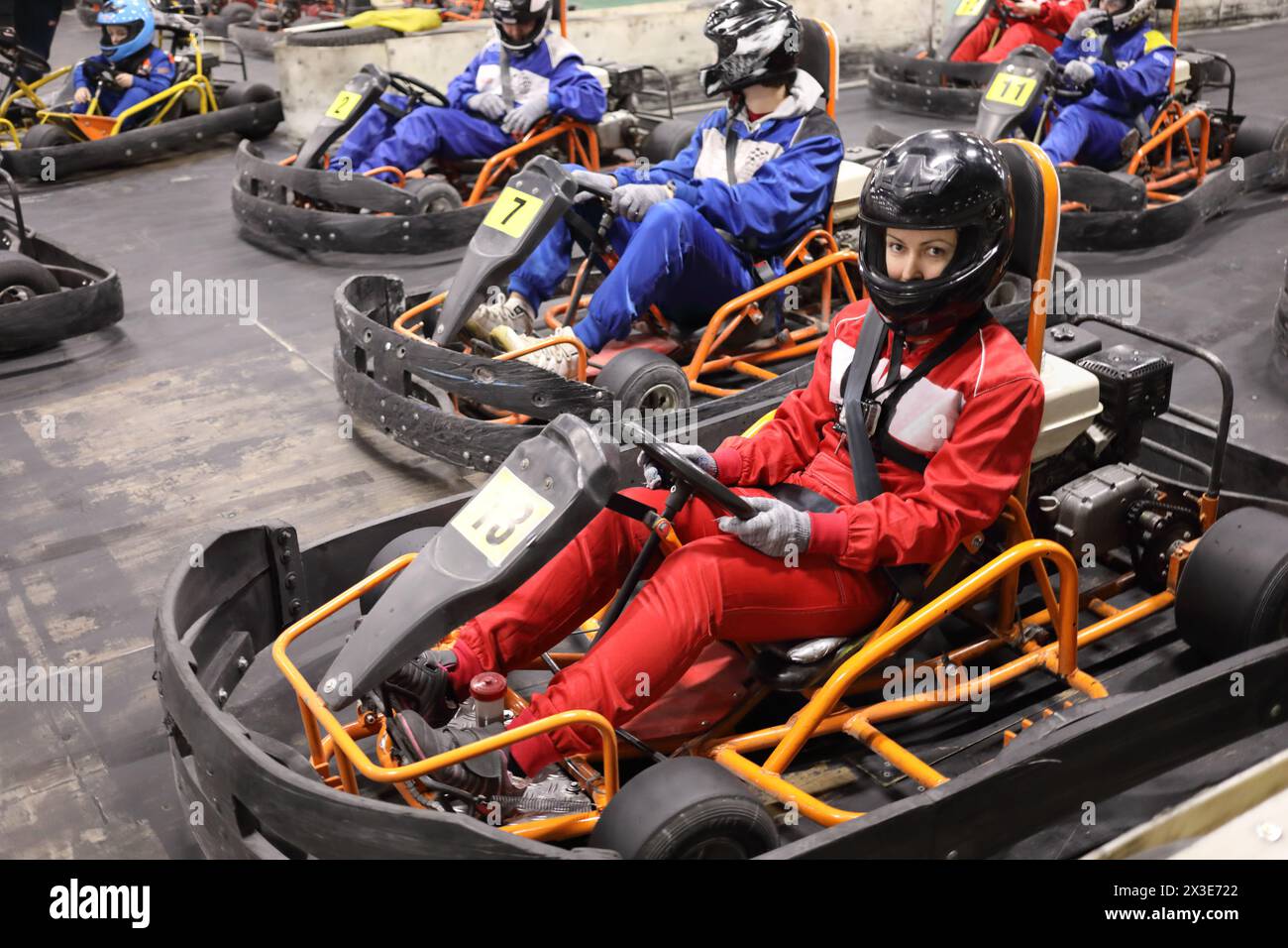 Four adults and two children prepare for driving karting, focus on ...