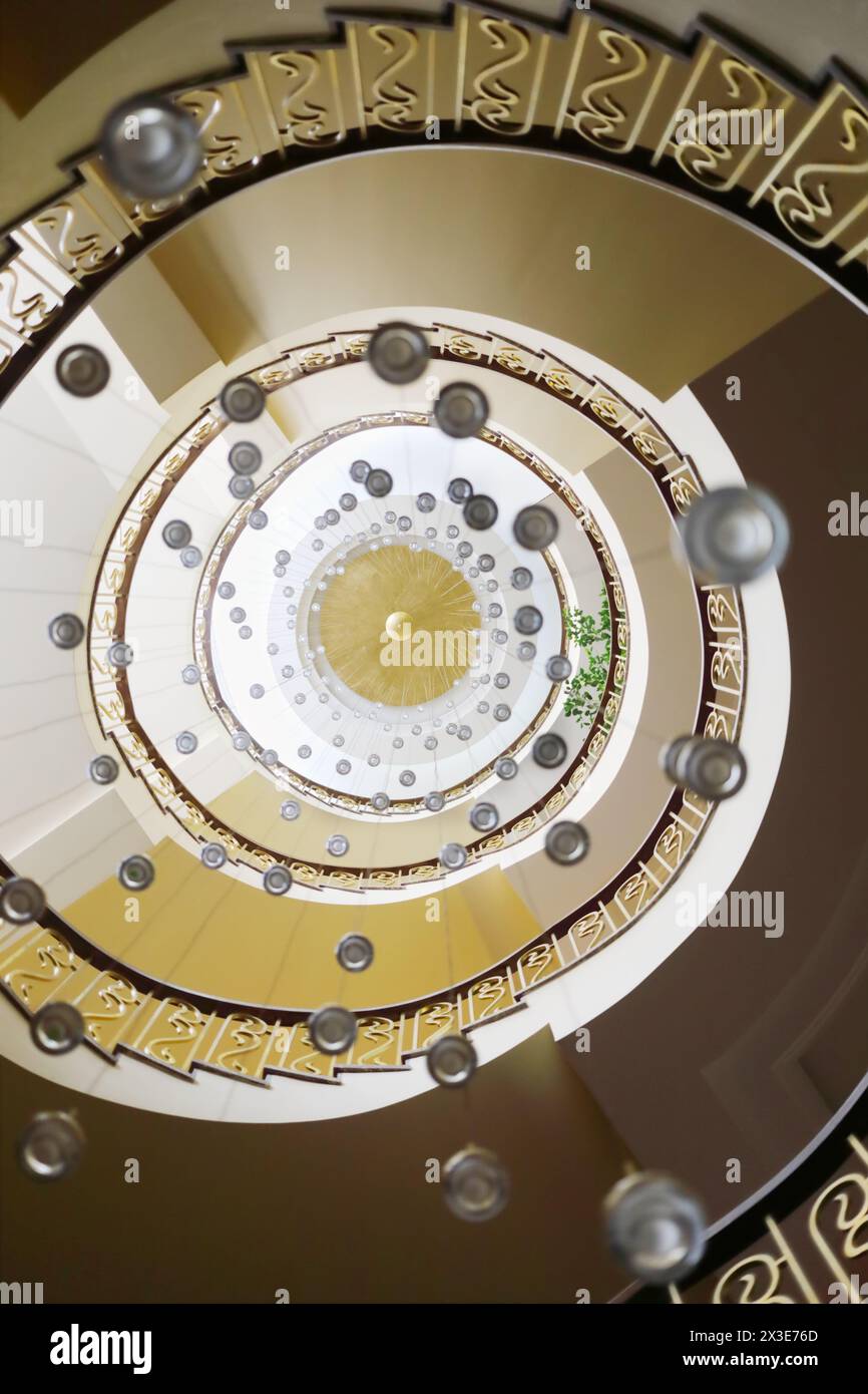 Beautiful spiral staircase with illumination and hanging balls in hotel ...