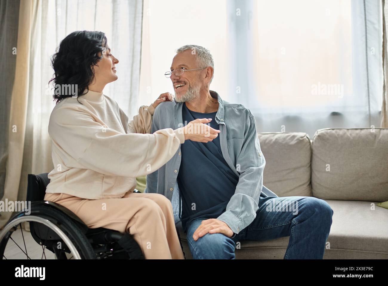 A woman in a wheelchair talking to a man, both engaged in a heartfelt ...