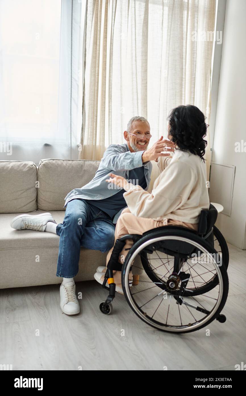 A man and a disabled woman hugging each other affectionately in a cozy ...