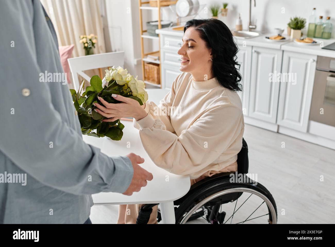 A disabled woman in a wheelchair holding a vibrant bouquet of flowers ...
