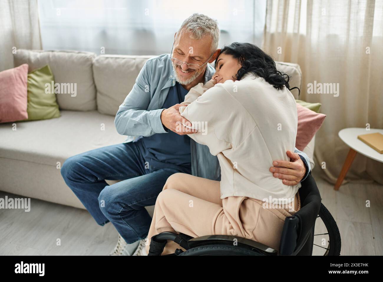 a disabled woman in a wheelchair embracing her husband with love and ...