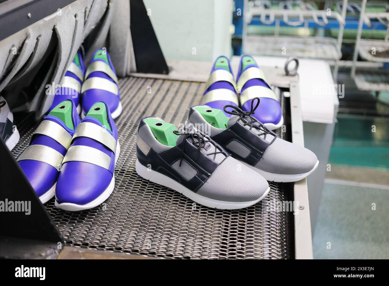 Conveyor with new sneakers pairs in workshop at modern shoes factory ...