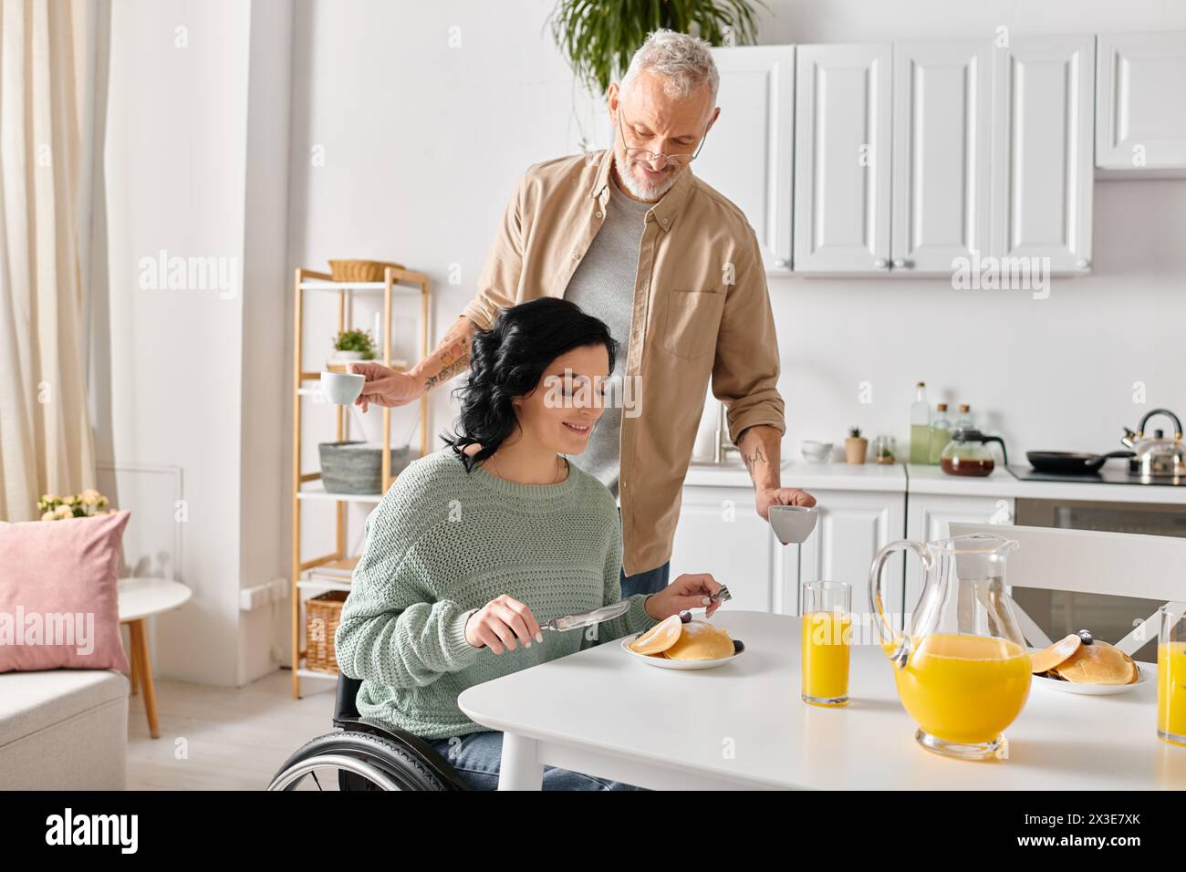 A disabled woman in a wheelchair and her husband cooking together in ...
