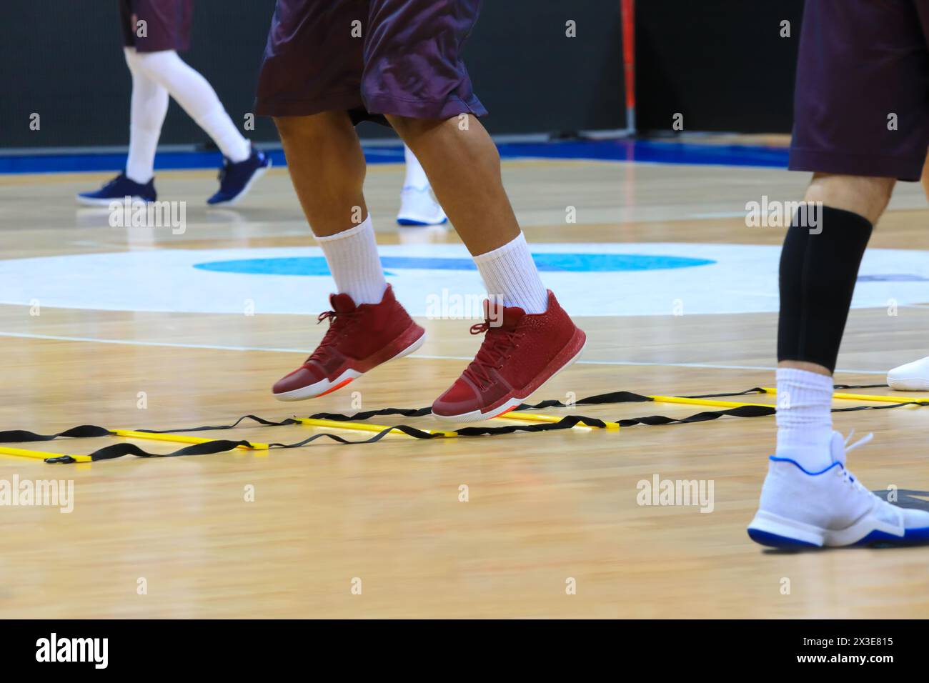 Legs of men in sport shoes and shorts during basketball training in ...