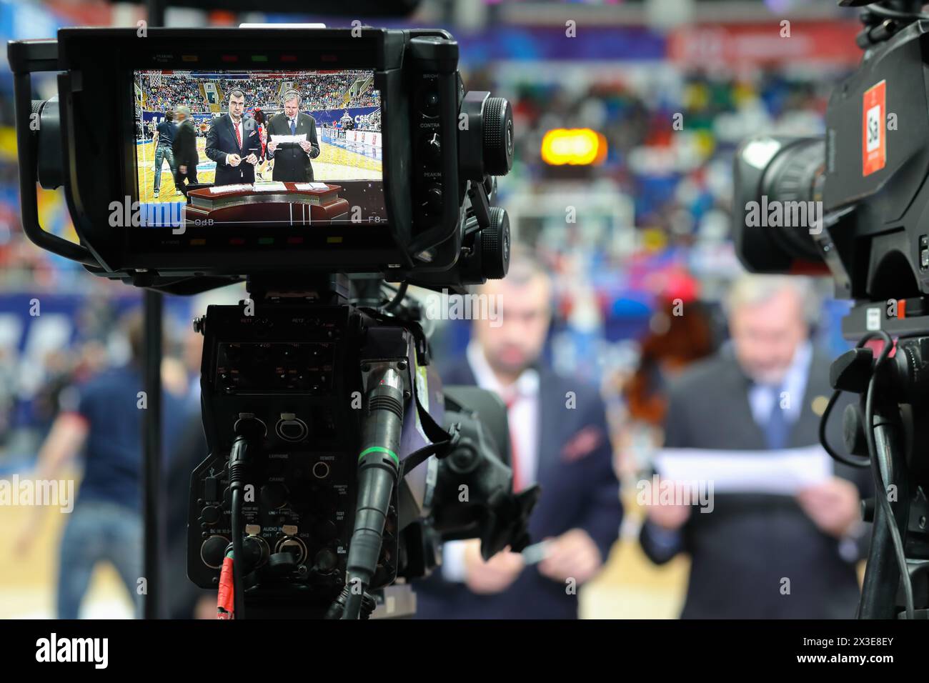 two Commentators at camera display at basketball game in stadium Stock ...