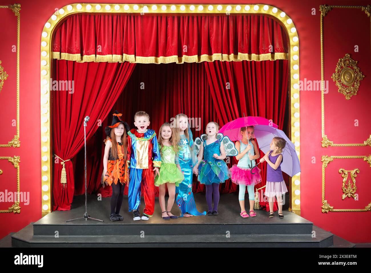 Seven happy children in costumes on red stage in theater, collage Stock ...