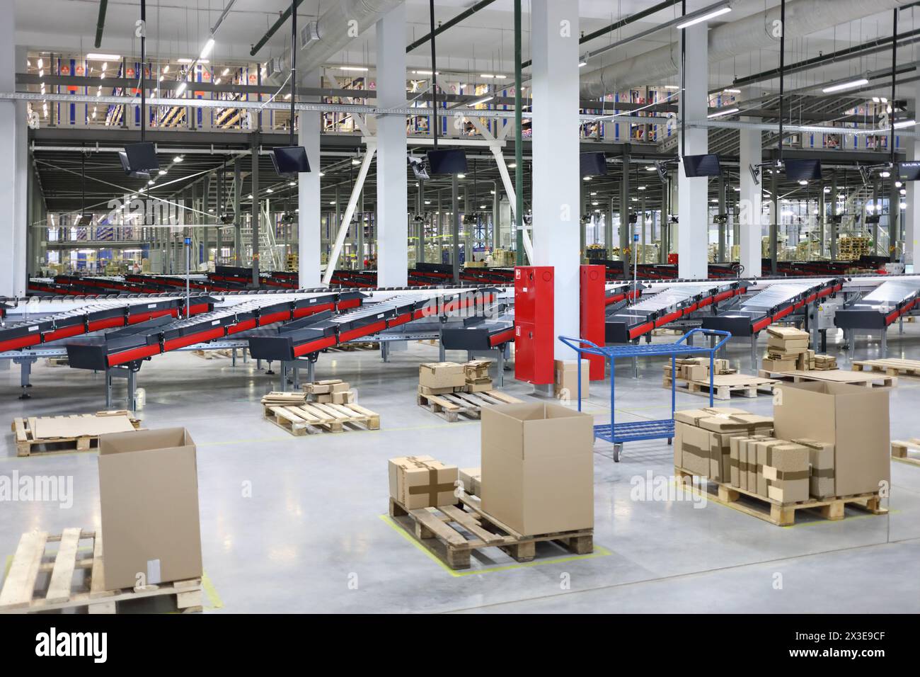 Big empty modern workshop with cardboard boxes, conveyors for sorting ...