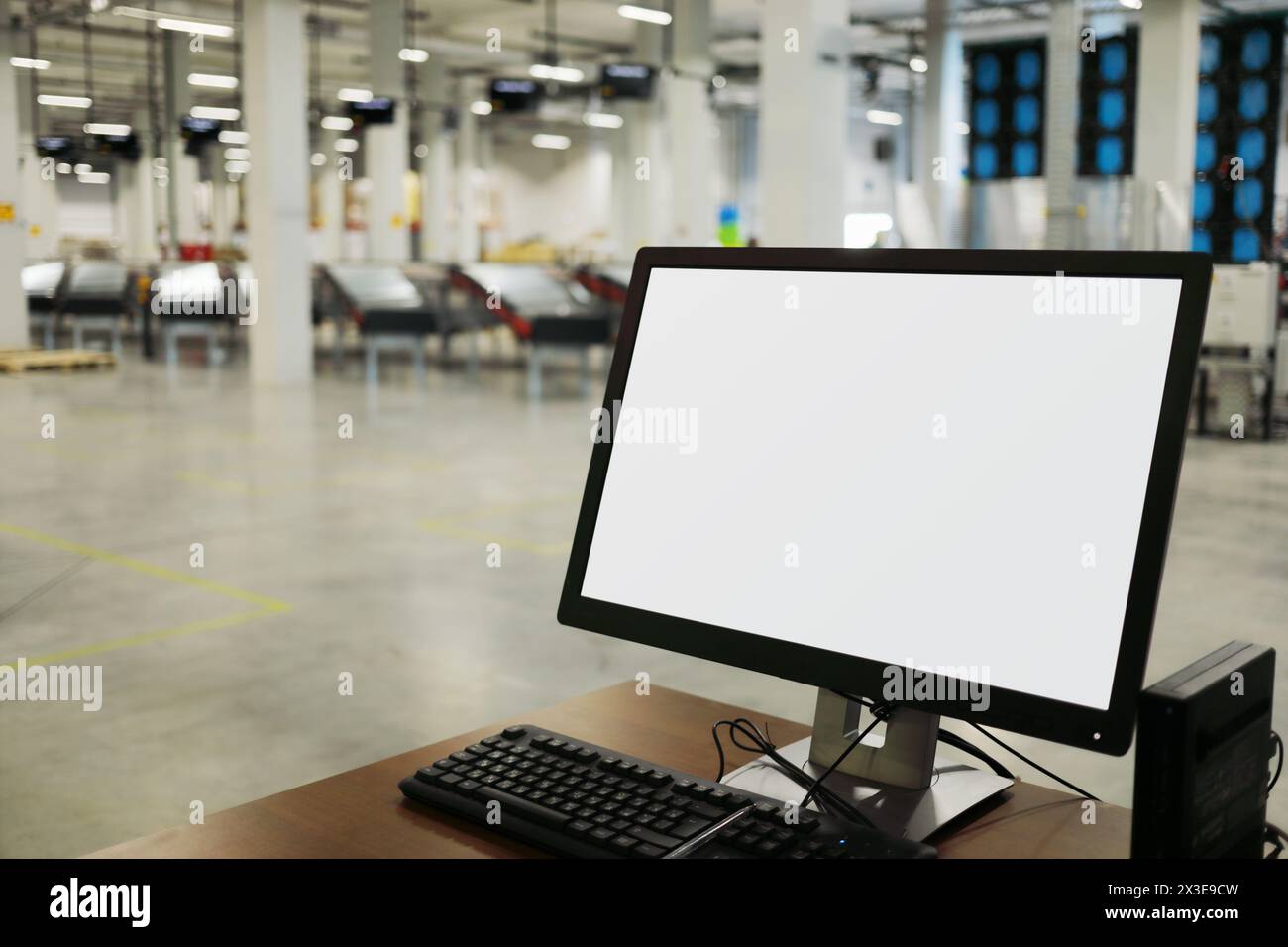 Display of computer at workplace in big empty modern warehouse Stock ...