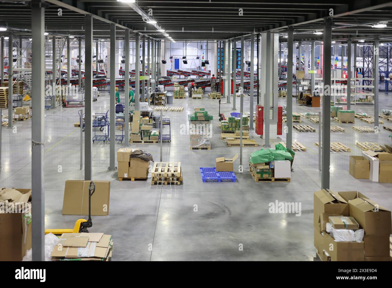 Big modern warehouse with cardboard boxes, conveyors for sorting of ...