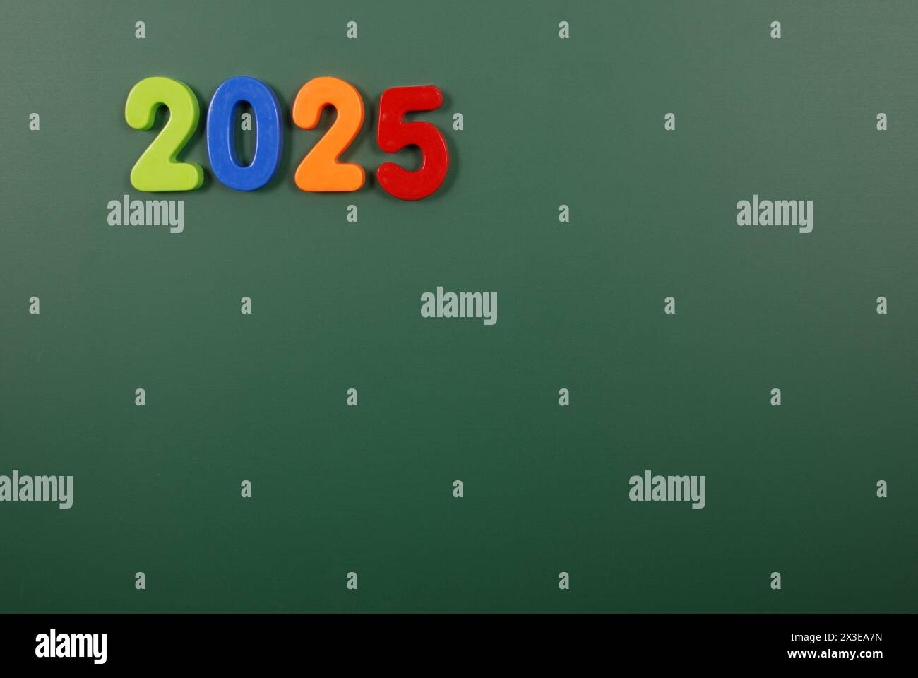 2025 year written in bright plastic magnetic letters stuck on a ...