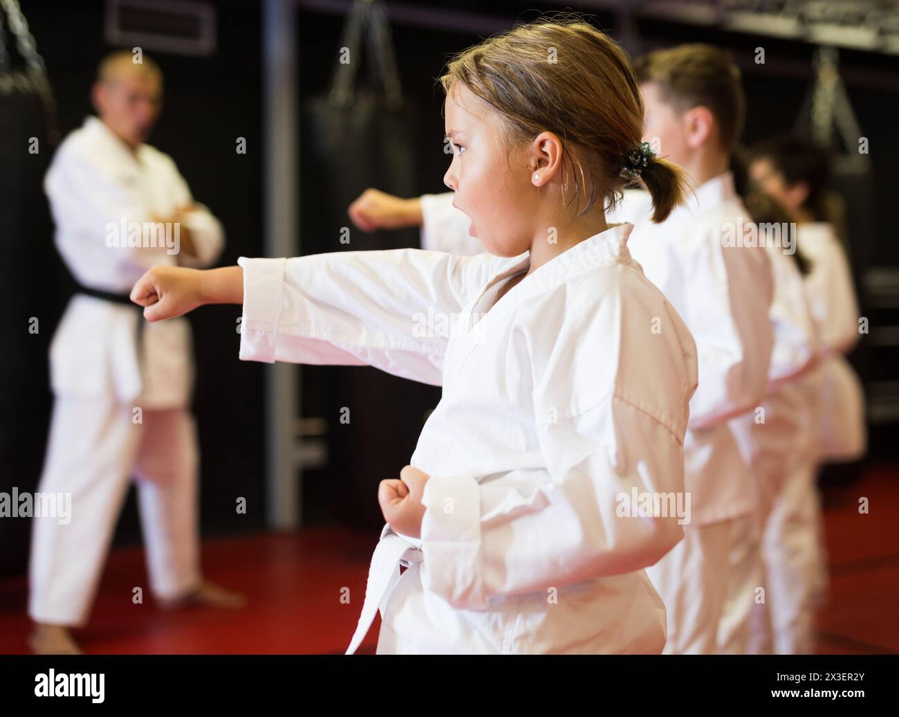 Children wearing karate uniform practicing new moves in group Stock ...