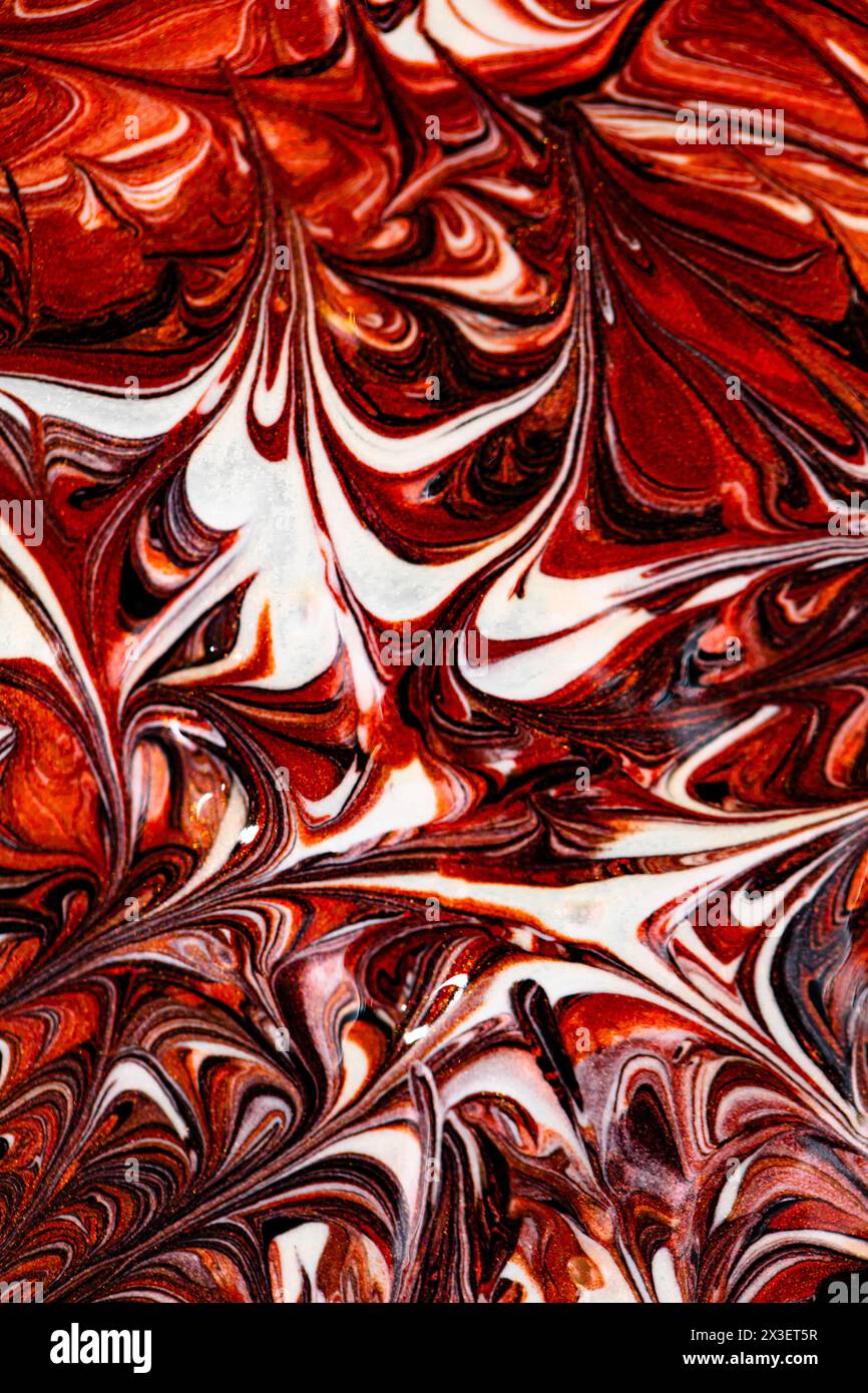 Closeup of red fluid metallic paint textured background for design ...