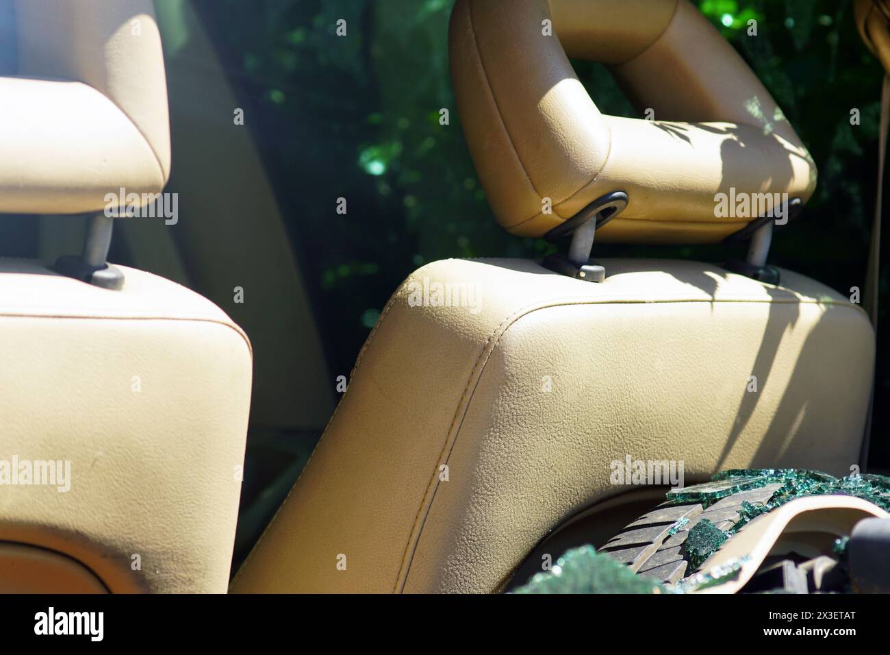 View through the broken rear window of a car: passenger seats and glass ...