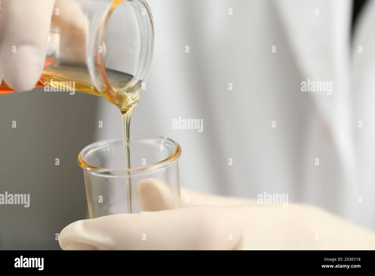 Lab worker pouring orange hi-res stock photography and images - Alamy