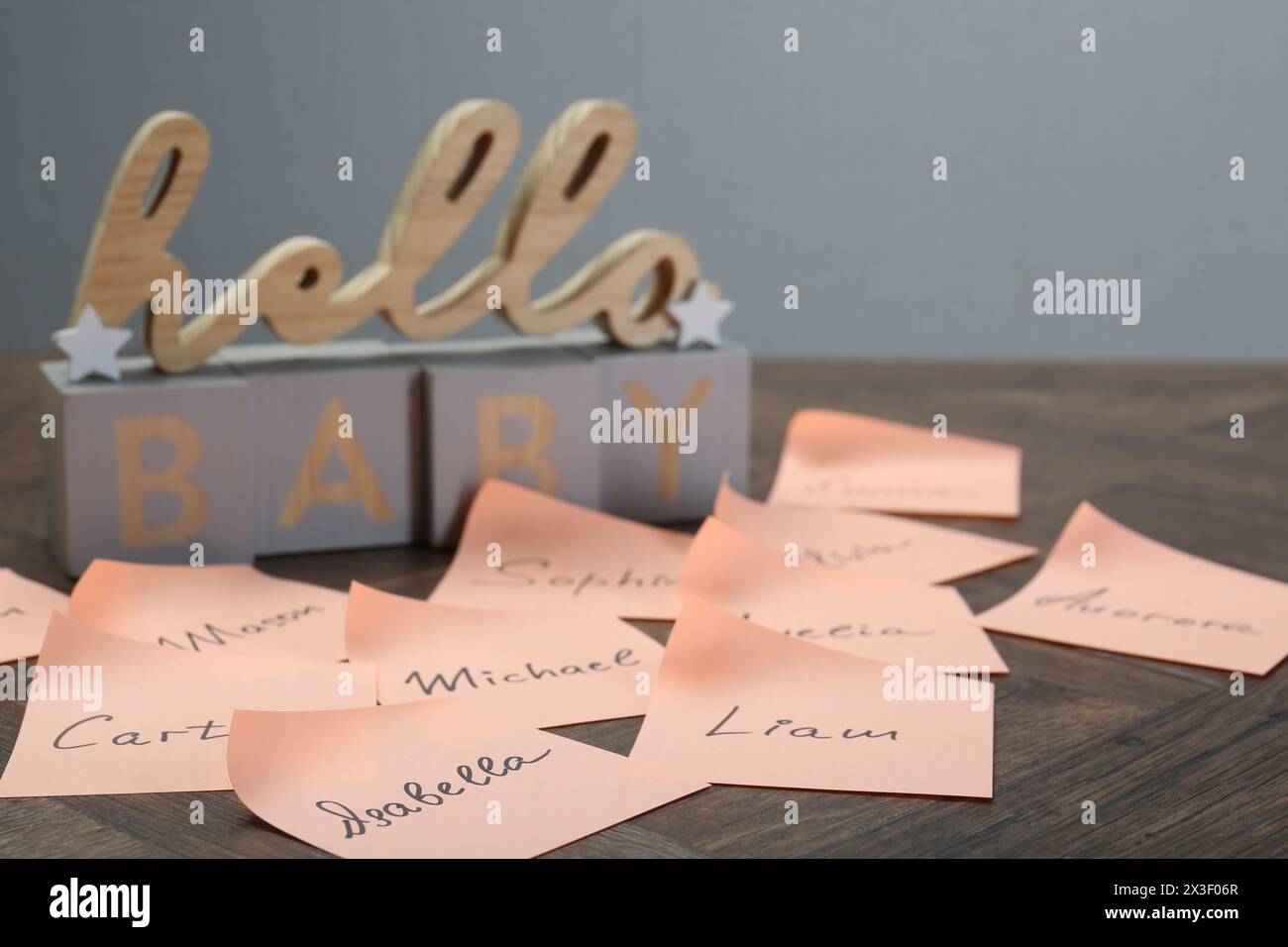 Cubes with phrase Hello Baby and paper stickers with different names on ...