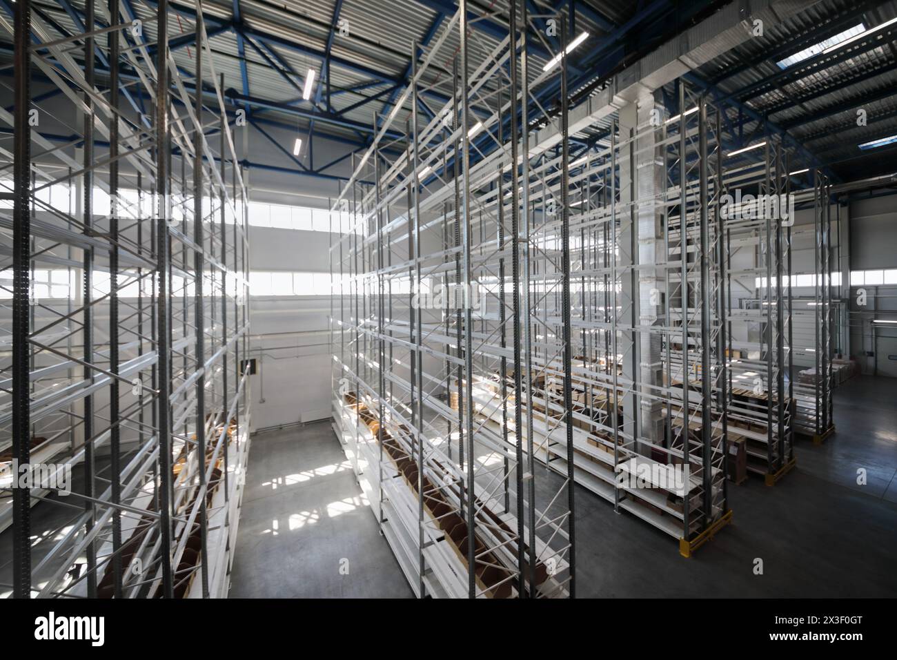 Modern warehouse with many shelves - long hallway in sorting center ...