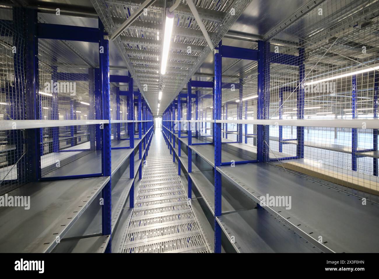 Big empty warehouse with many shelves - long hallway in sorting center ...