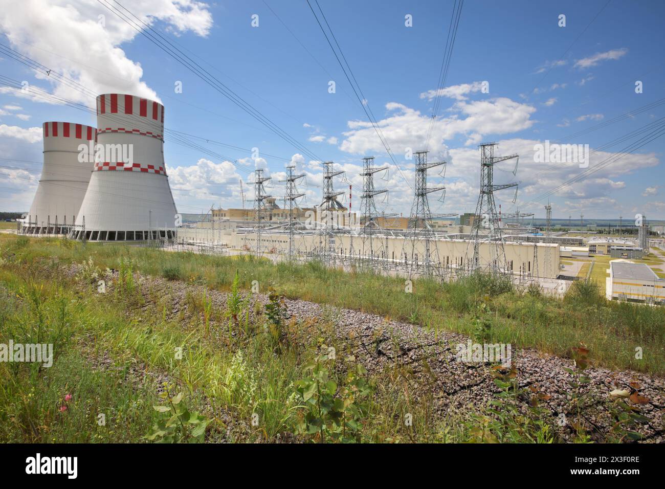 Smoking pipes, poles with wires of atomic thermal power plant at summer ...