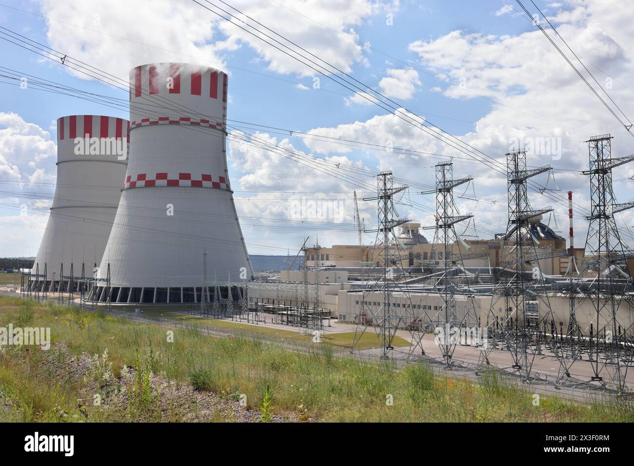 Smoking pipes, poles with wires of atomic thermal power plant at summer ...