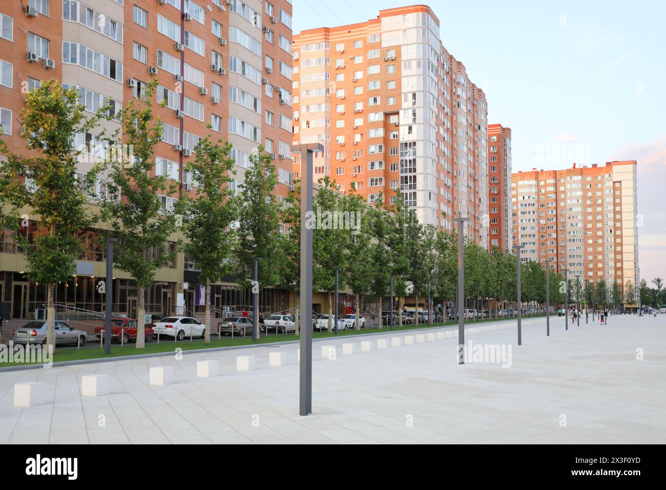 Residential buildings, alley with trees and lanterns at sunny day in ...