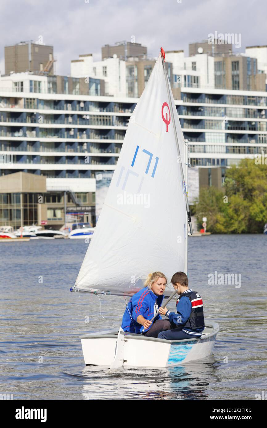 Boy and his trainer sail on small yacht in Yacht club Stock Photo - Alamy