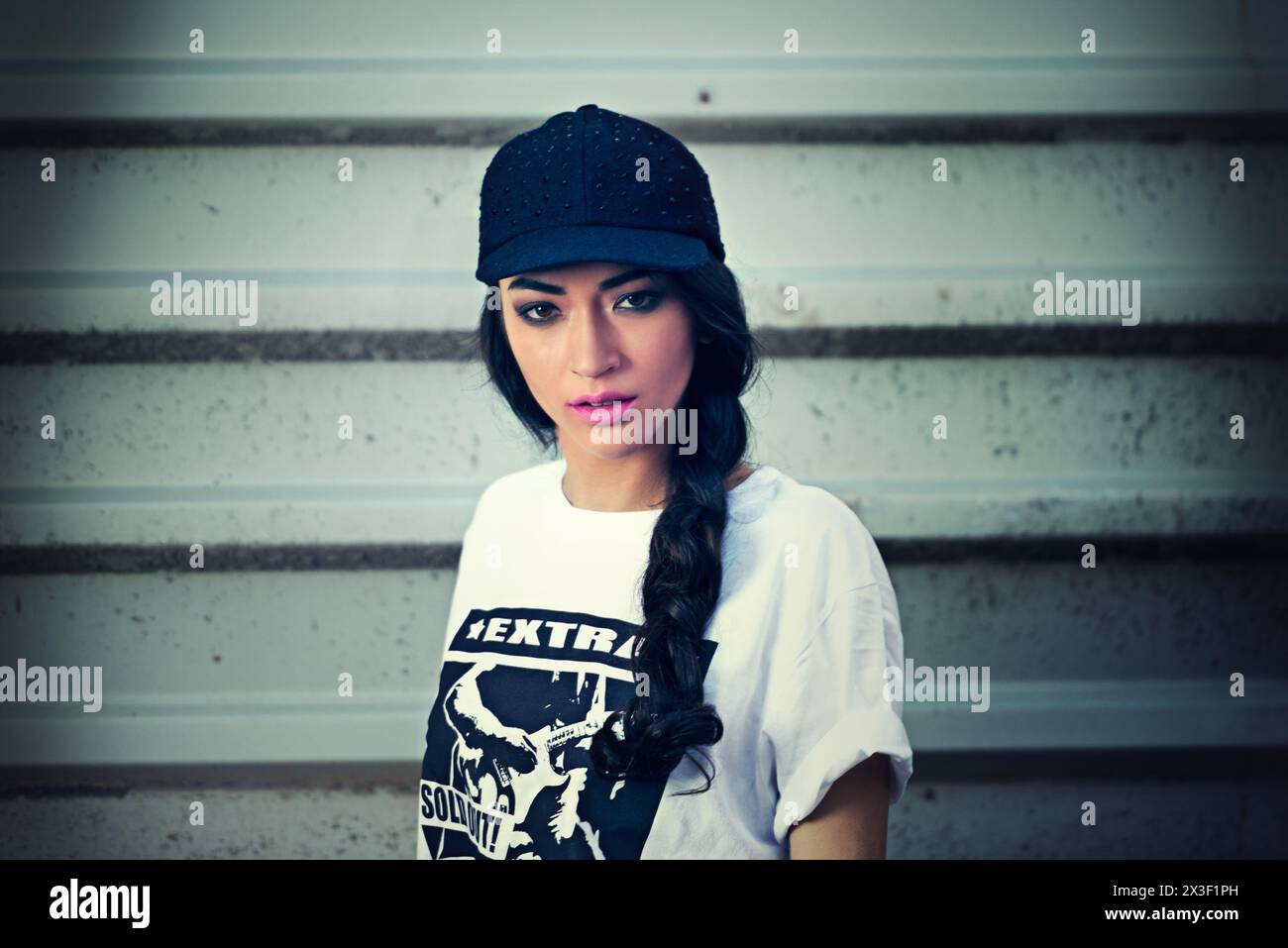 Garage, portrait and woman in city with fashion, cap or gender neutral ...