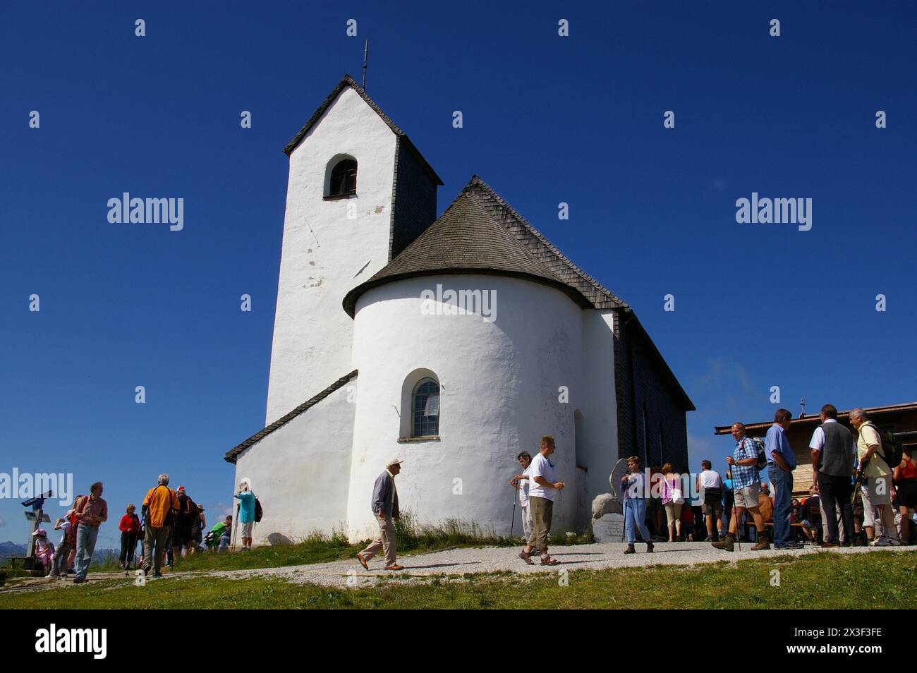 Beautiful white church on the mountainside under a blue sky Stock Photo ...