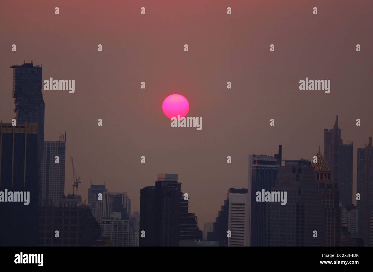 Stunning Bangkok City Skyline with the Bright Sun over Deep Maroon Sky ...