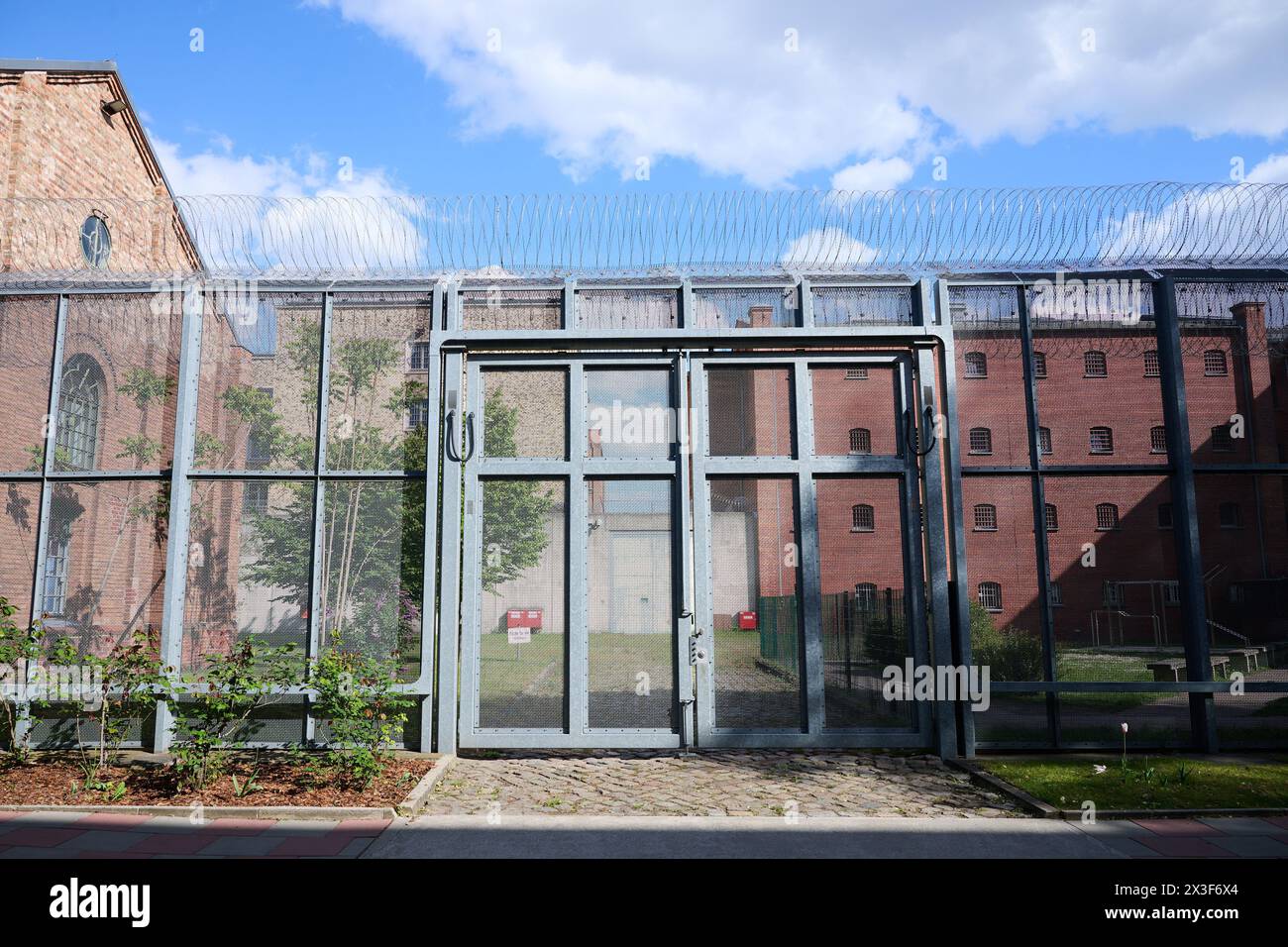 Berlin, Germany. 26th Apr, 2024. A huge iron gate with rolled barbed ...