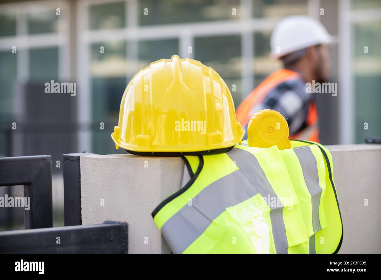 Yellow safety helmet are provided along with reflective vests for ...