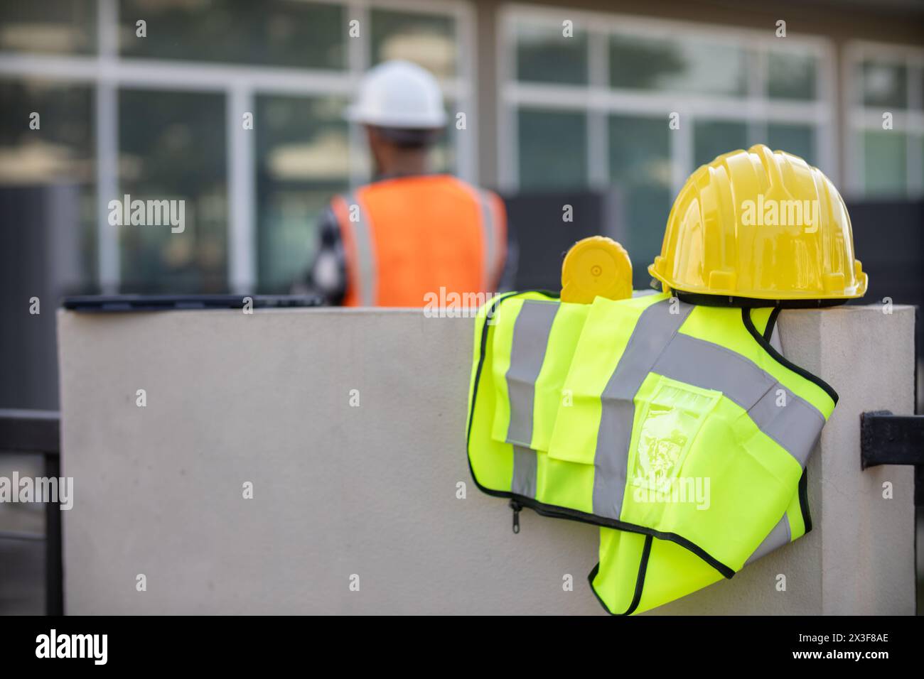 Yellow safety helmet are provided along with reflective vests for ...