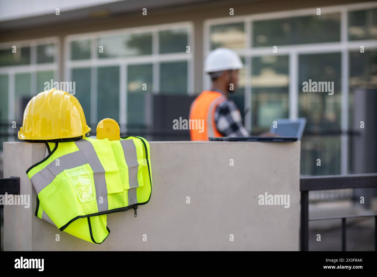 Yellow safety helmet are provided along with reflective vests for ...