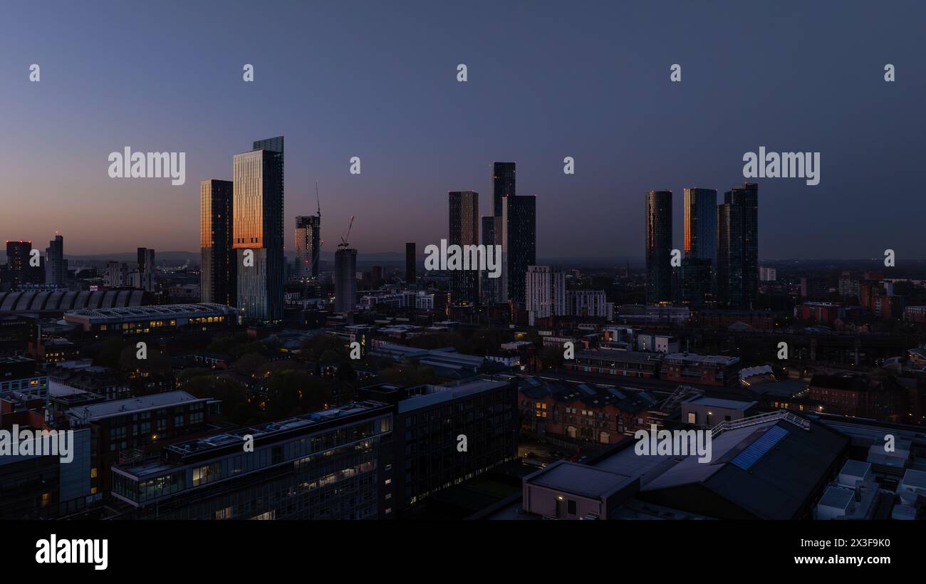 The fading light of twilight casts a soft glow on the cityscape ...